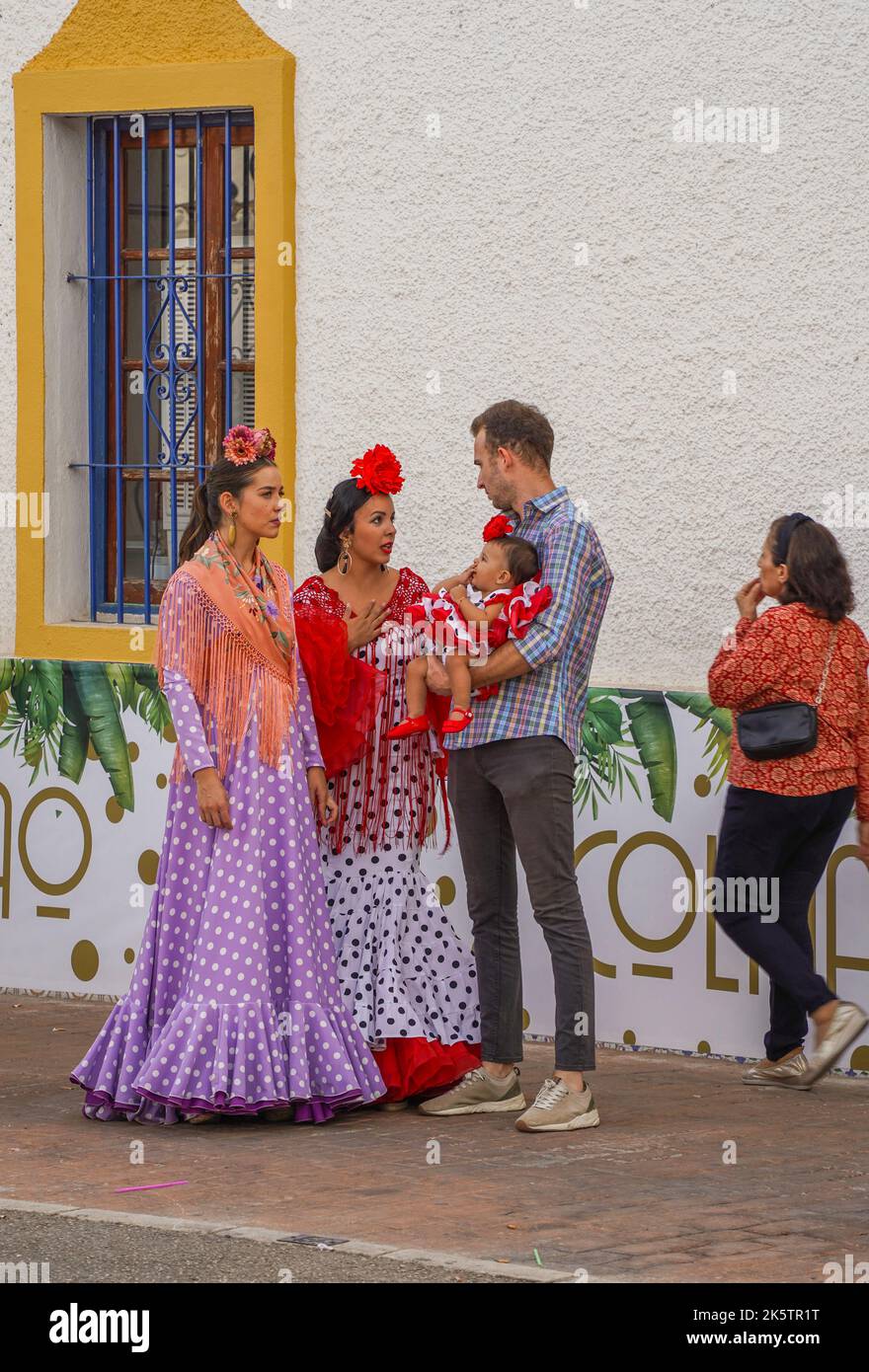Spanish families, dressed traditionally celebrating at the annual fair ...