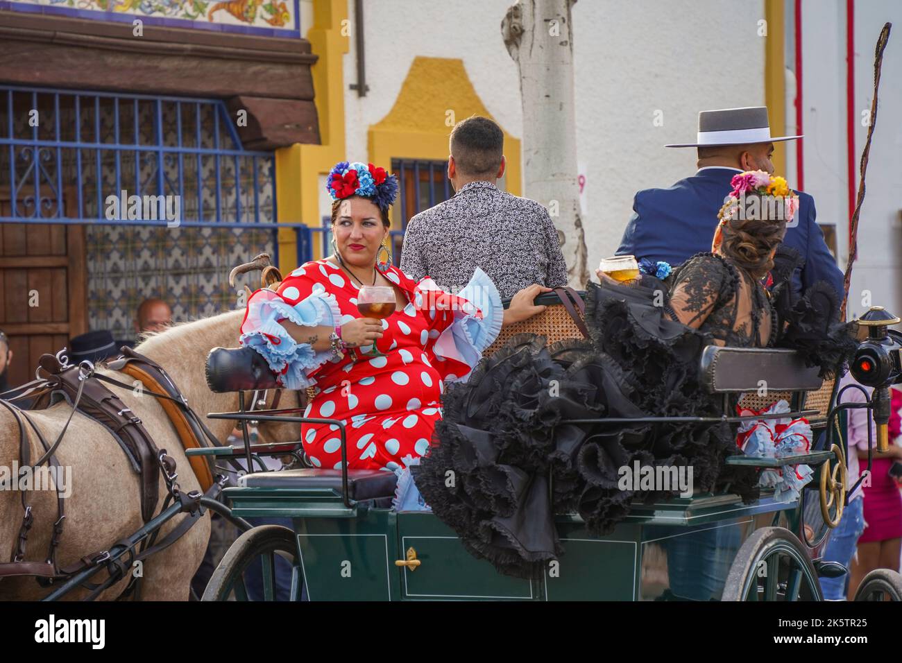 Horse carriage with driver and two women drinking, at the annual fair ...