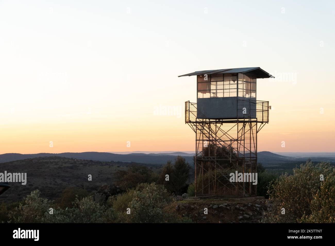 Watchtower for fire surveillance in silhouette on hilltop overlooking ...
