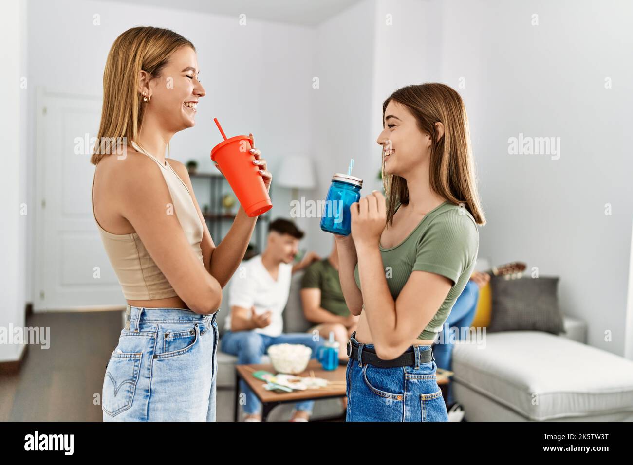 Two young women on party smiling happy and drinking soda at home Stock ...