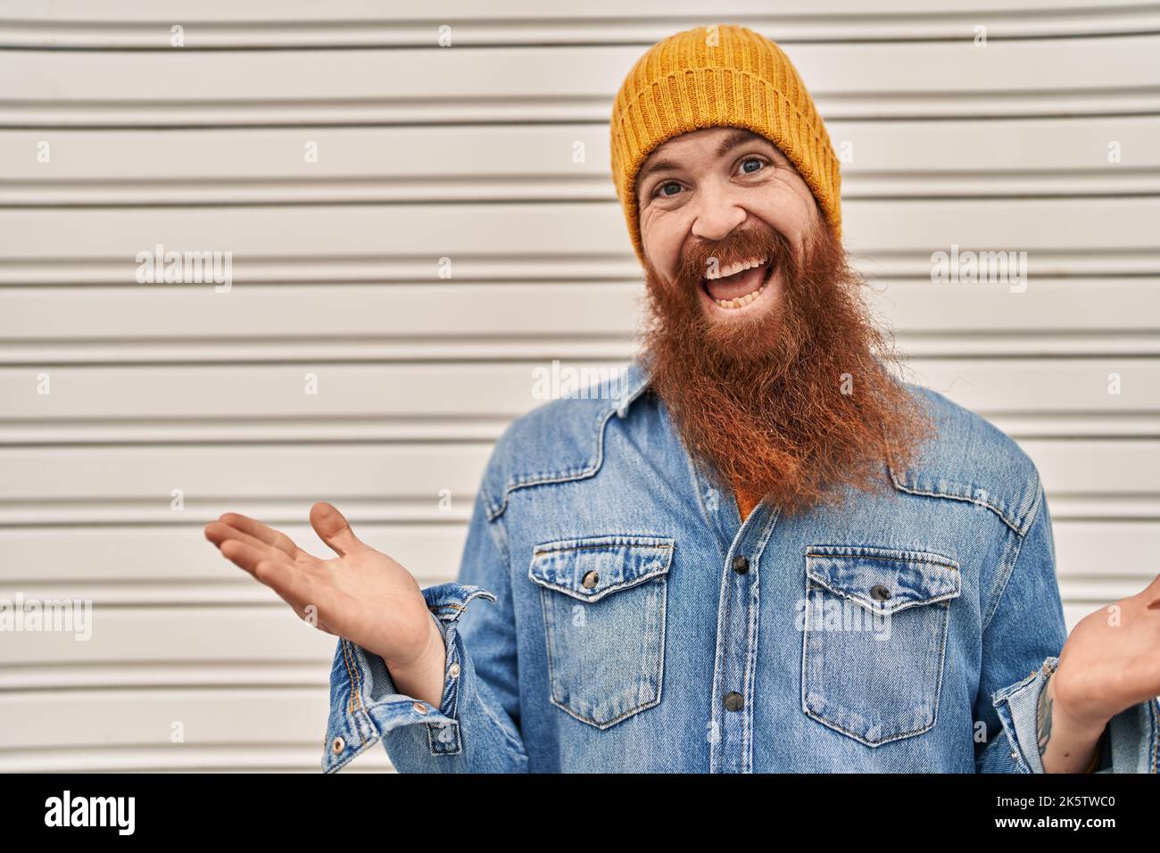 Caucasian man with long beard waring wool hat celebrating achievement ...