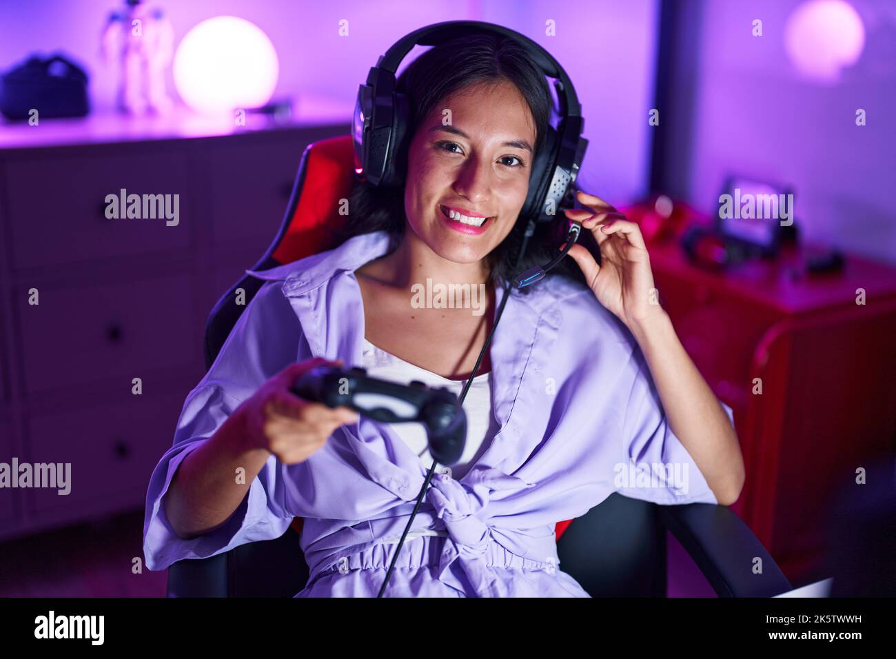 Young beautiful hispanic woman streamer playing video game using ...