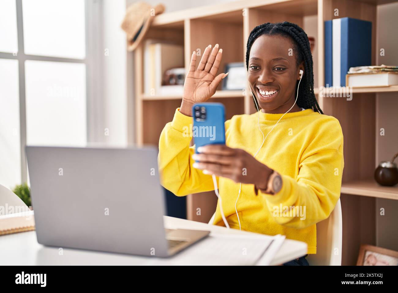 Beautiful black woman doing video call with smartphone looking positive ...