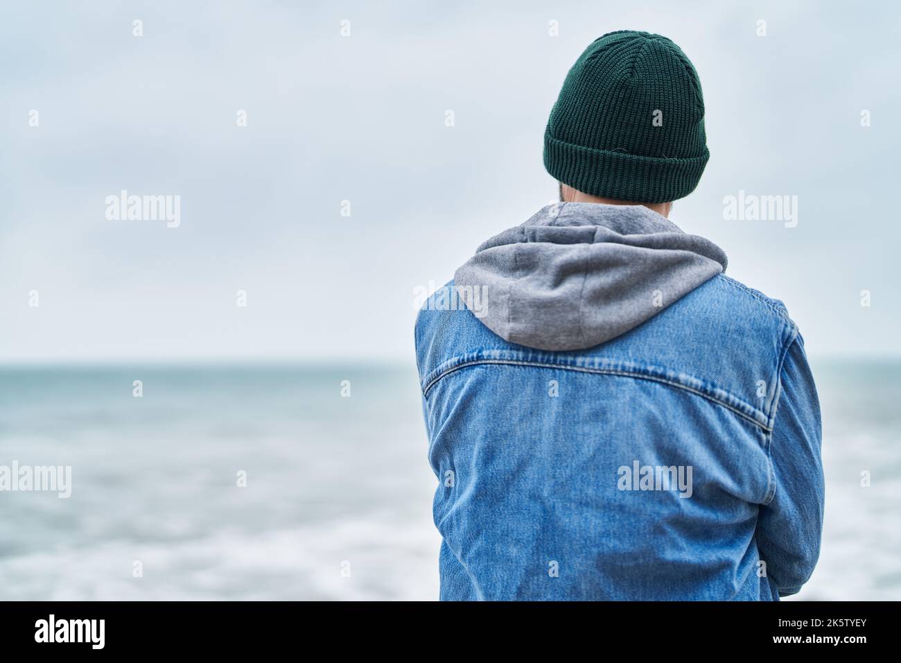 Young bald man standing on back view at seaside Stock Photo - Alamy