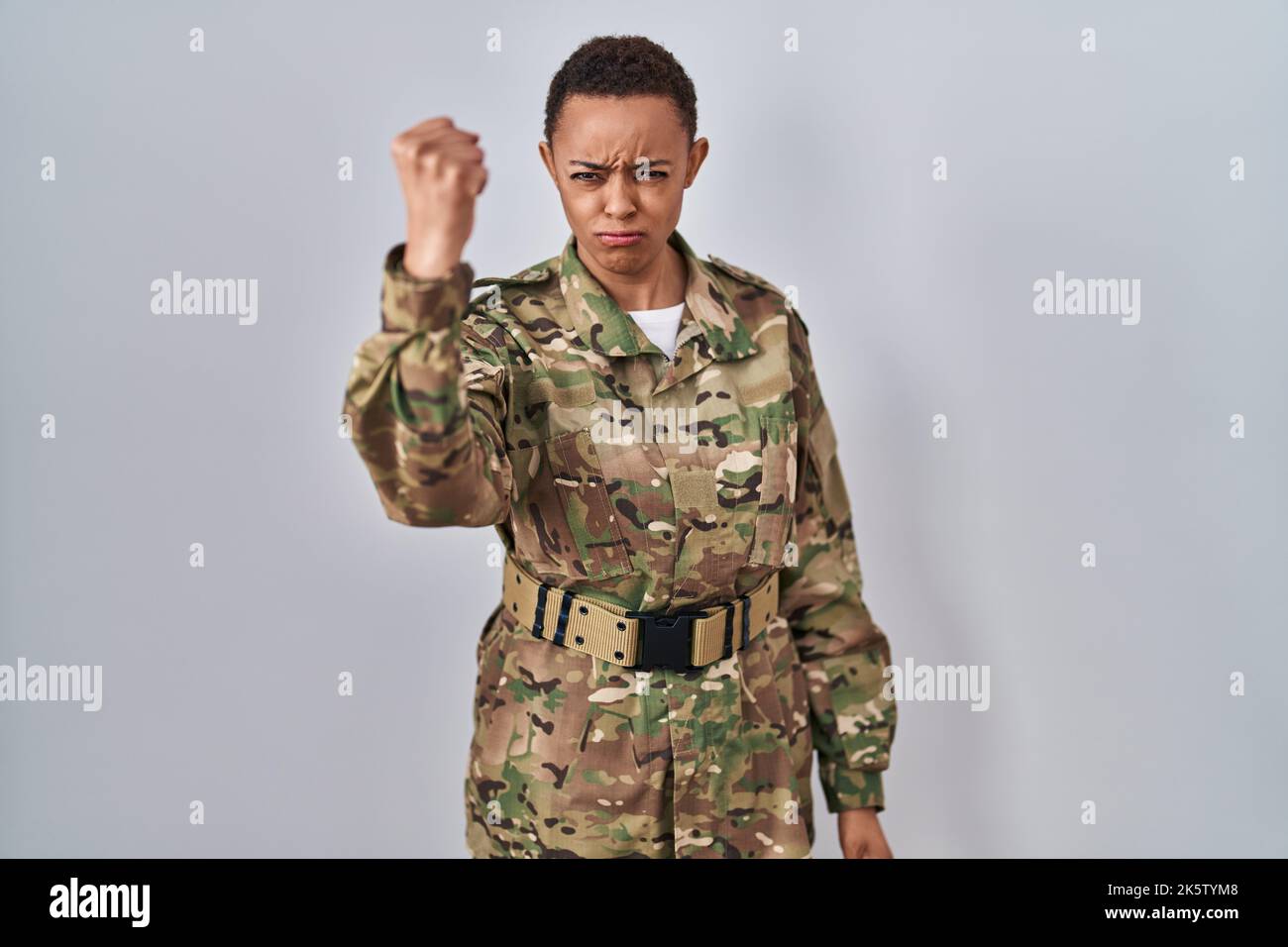 Beautiful african american woman wearing camouflage army uniform angry ...