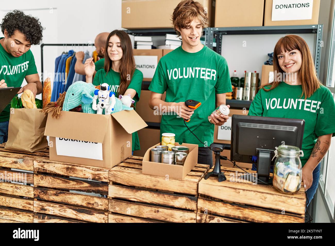 Group of young volunteers smiling happy working at charity center Stock ...