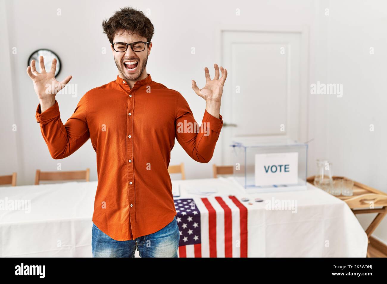 Hispanic man standing by election room celebrating mad and crazy for ...