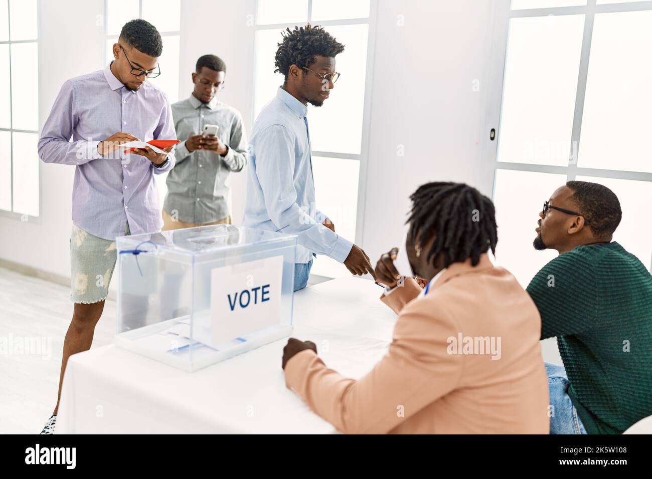 Group of young african american voter people putting vote in ballot ...