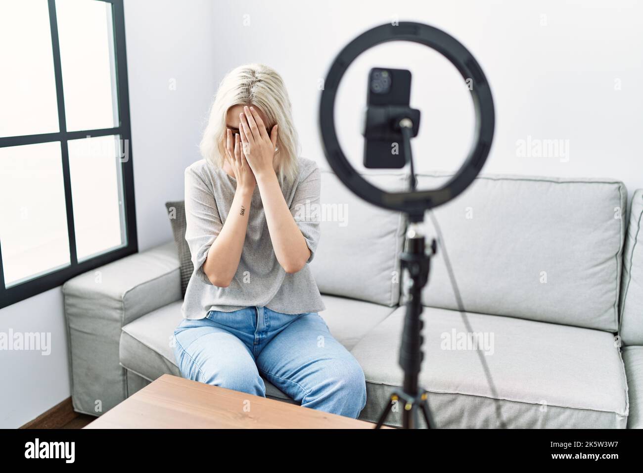 Young caucasian woman recording vlog tutorial with smartphone at home ...