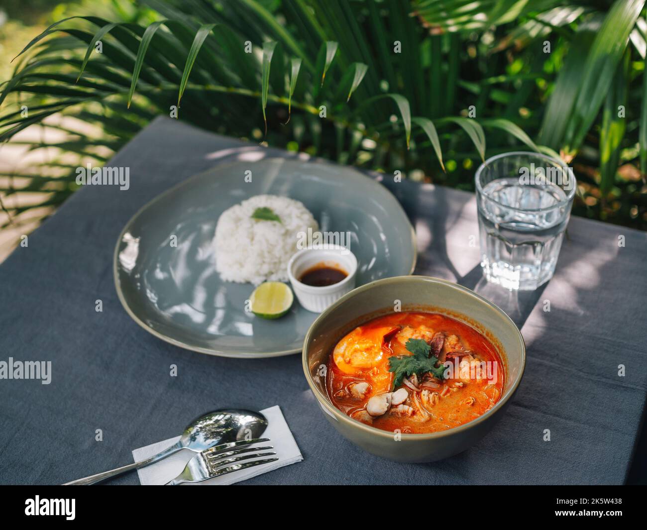 Asian soup 'Laksa' under palm tree at sunny day Stock Photo - Alamy