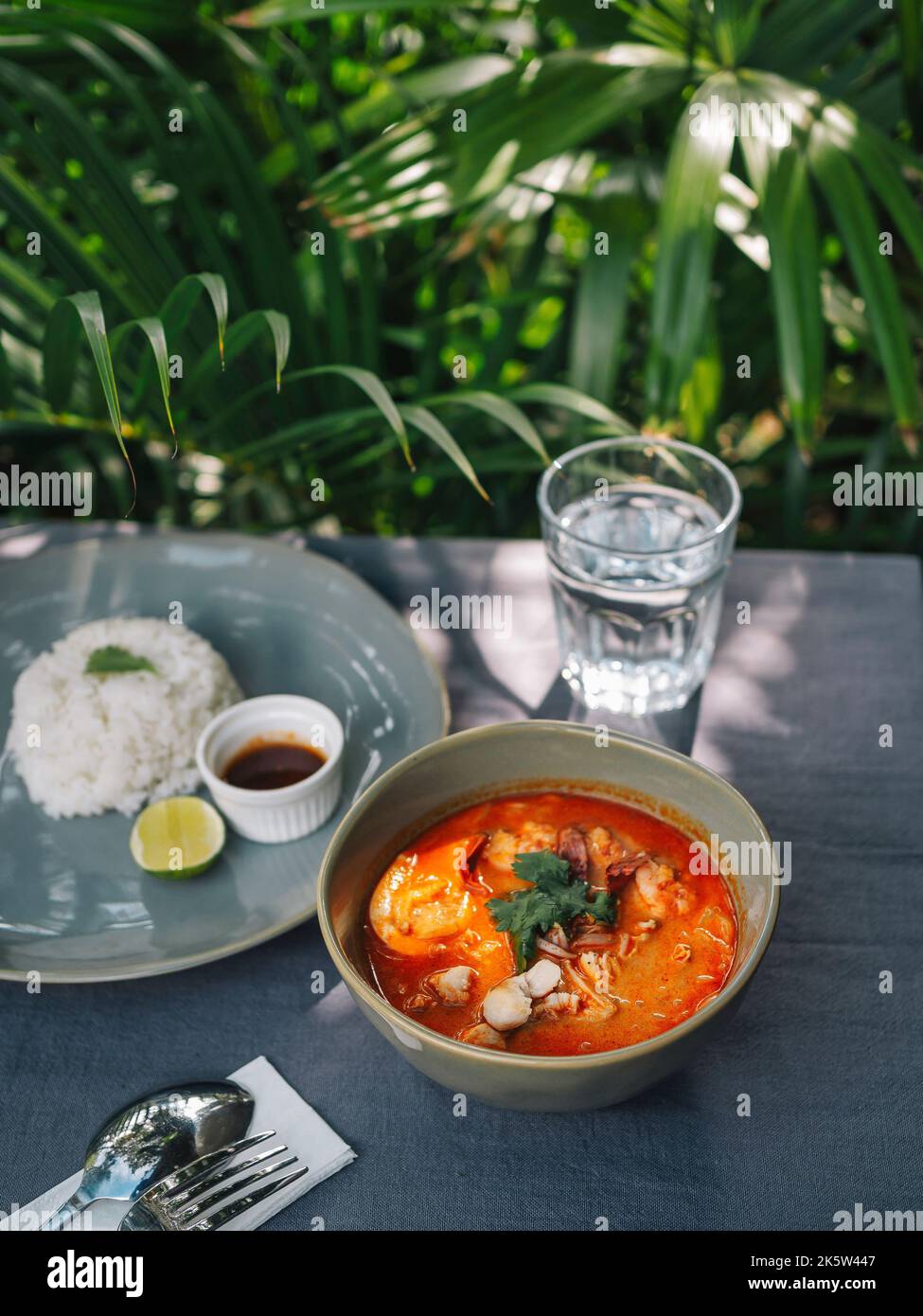Asian soup 'Laksa' under palm tree at sunny day Stock Photo - Alamy