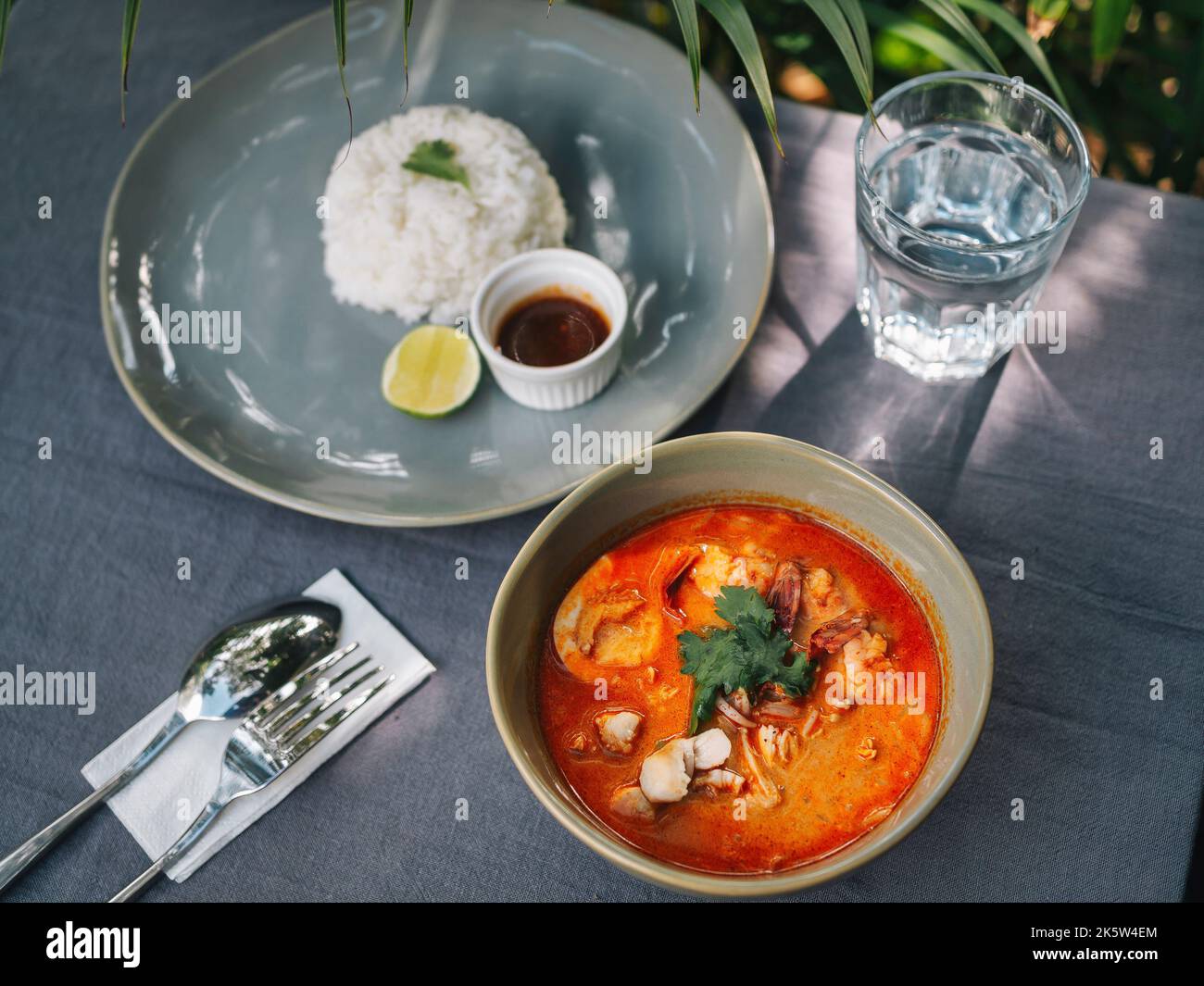 Asian soup 'Laksa' under palm tree at sunny day Stock Photo - Alamy