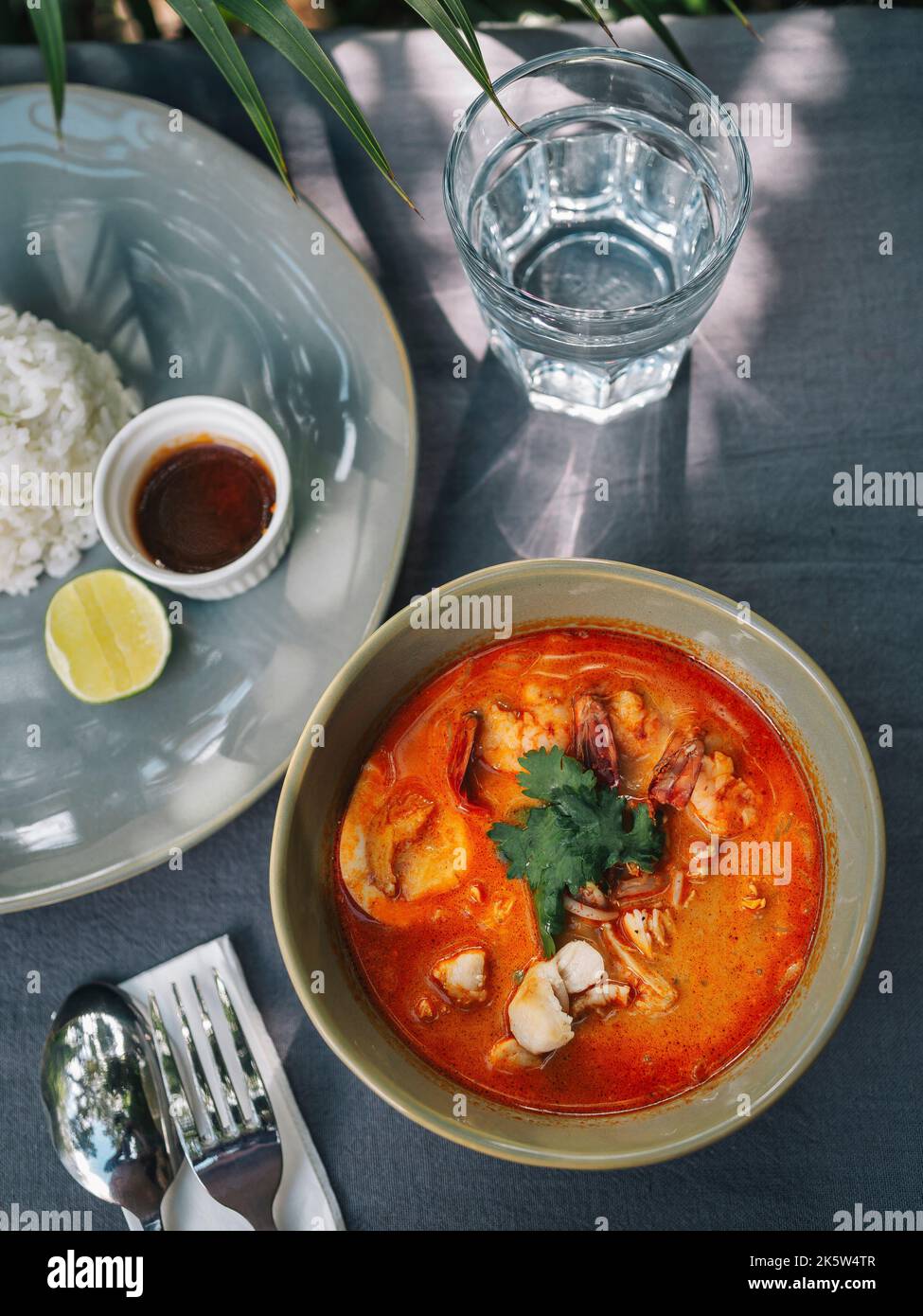 Asian soup 'Laksa' under palm tree at sunny day Stock Photo - Alamy