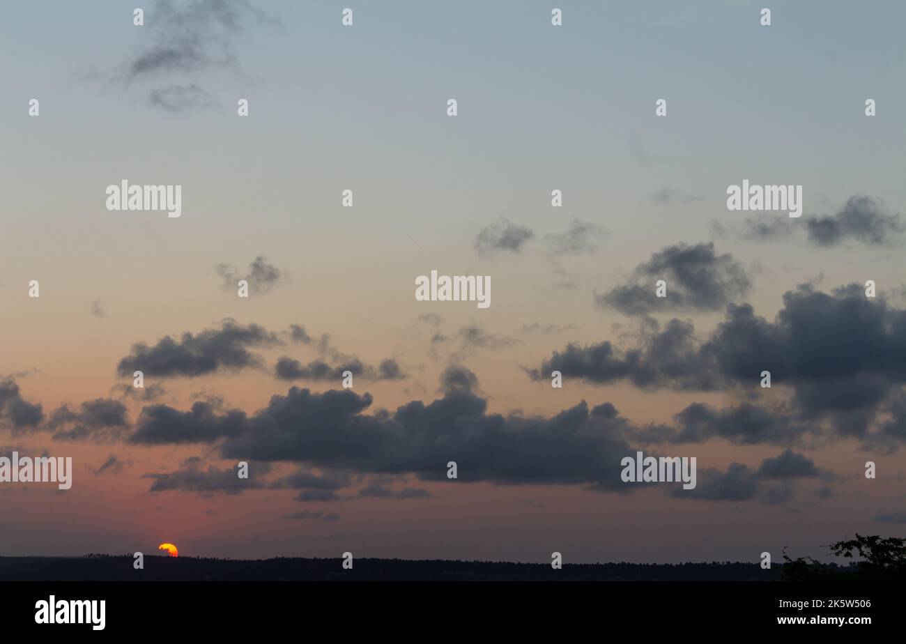 Sun disk during sunset. Isolated clouds in the sky. Skies replacement ...