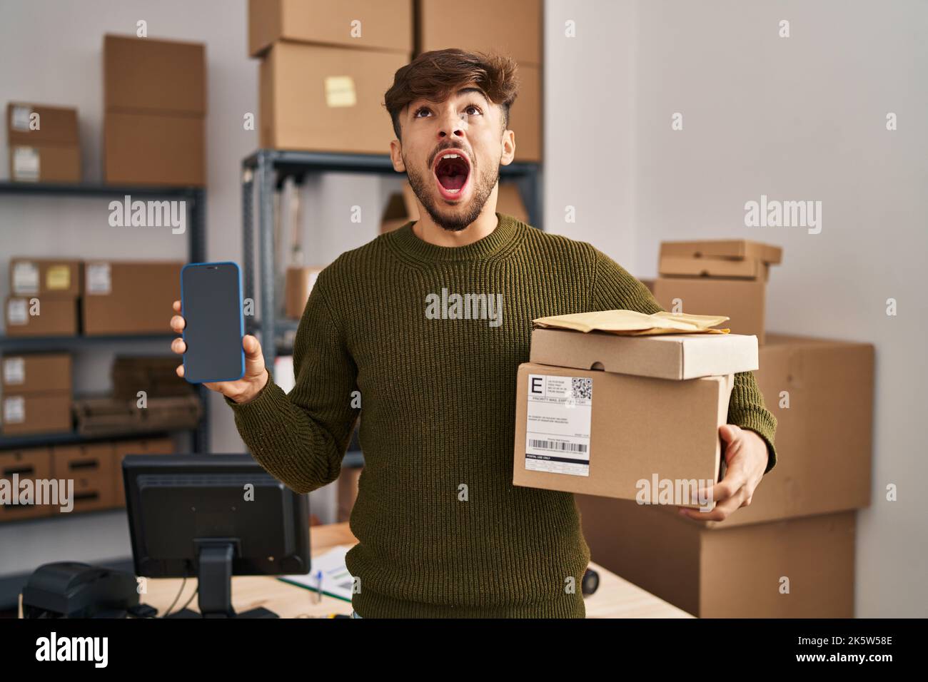 Arab man with beard working at small business ecommerce holding ...