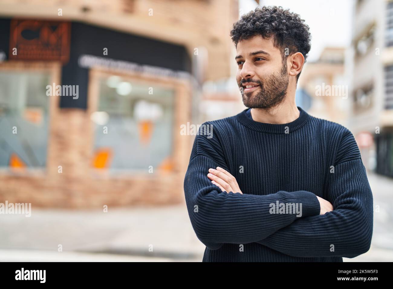 Young arab man smiling confident standing with arms crossed gesture at ...