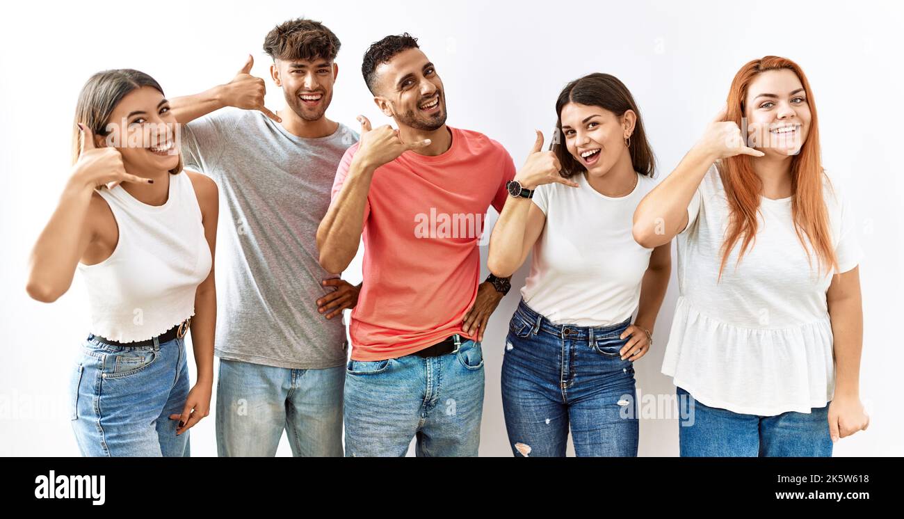 Group of young friends standing together over isolated background ...