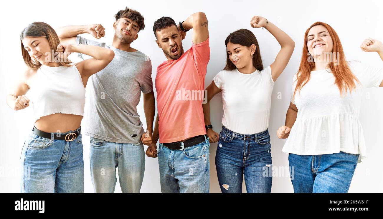 Group of young friends standing together over isolated background ...