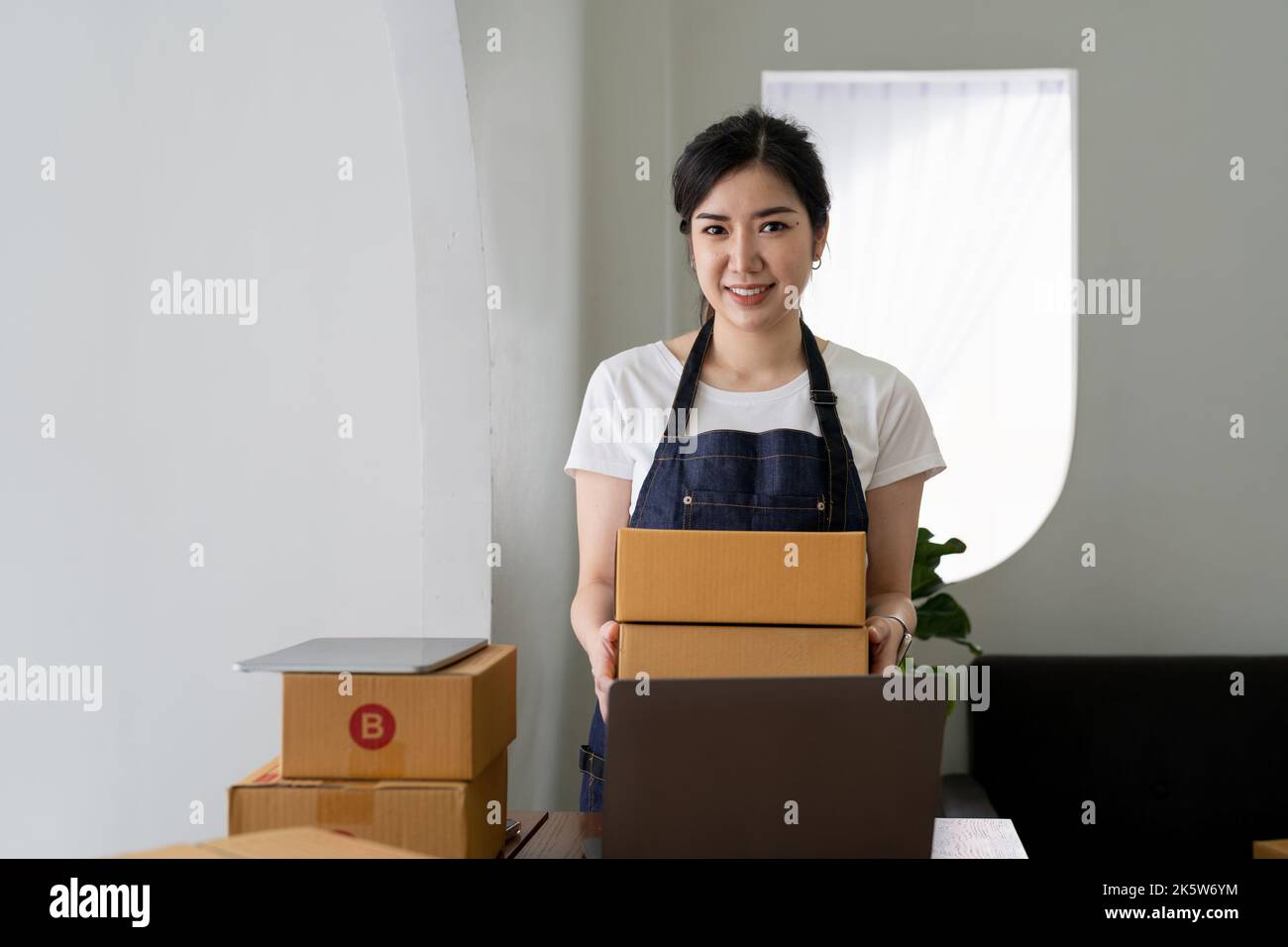 Portrait young attractive asia female owner startup business look at ...