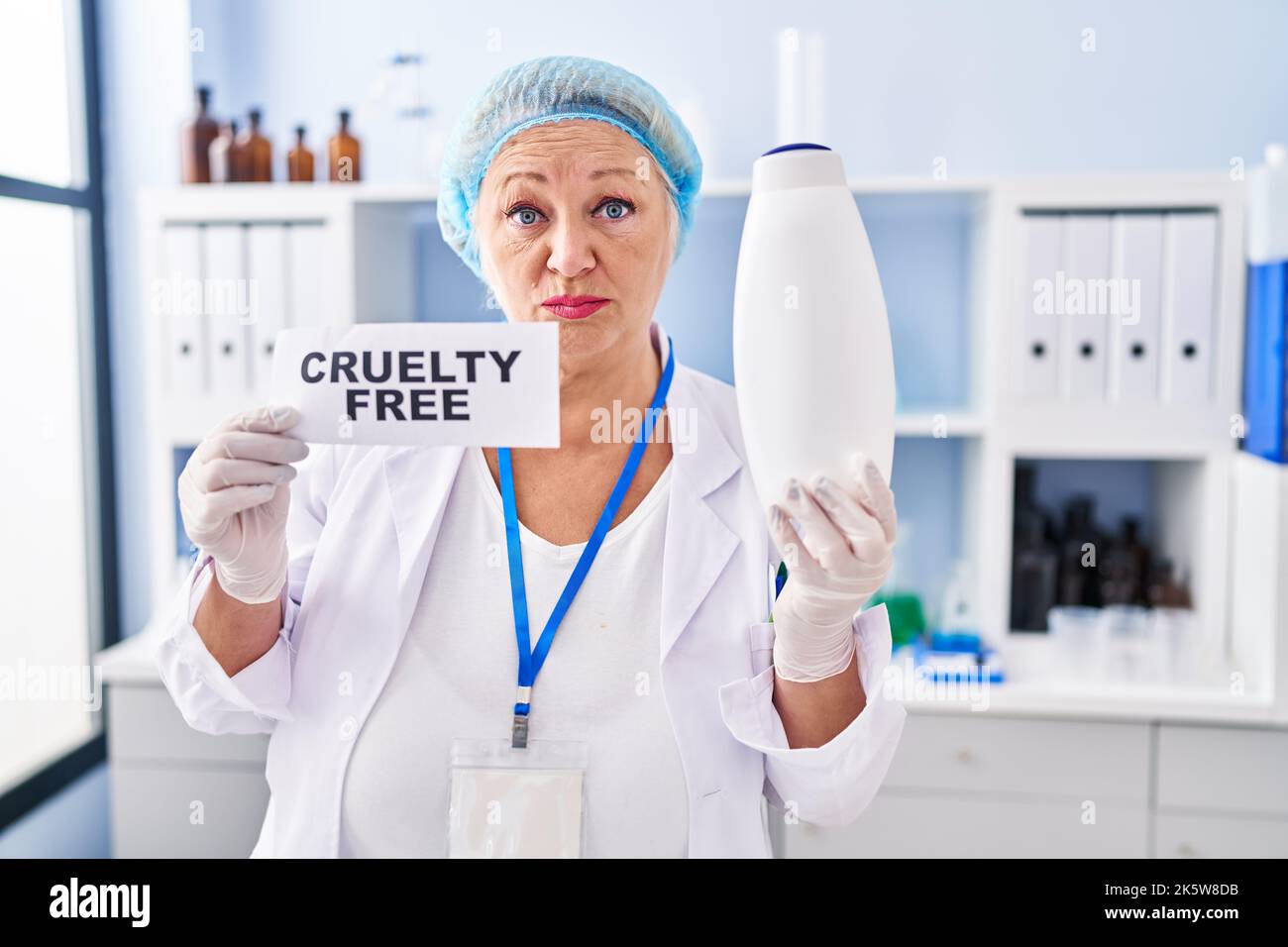 Middle age caucasian woman working on cruelty free laboratory depressed ...