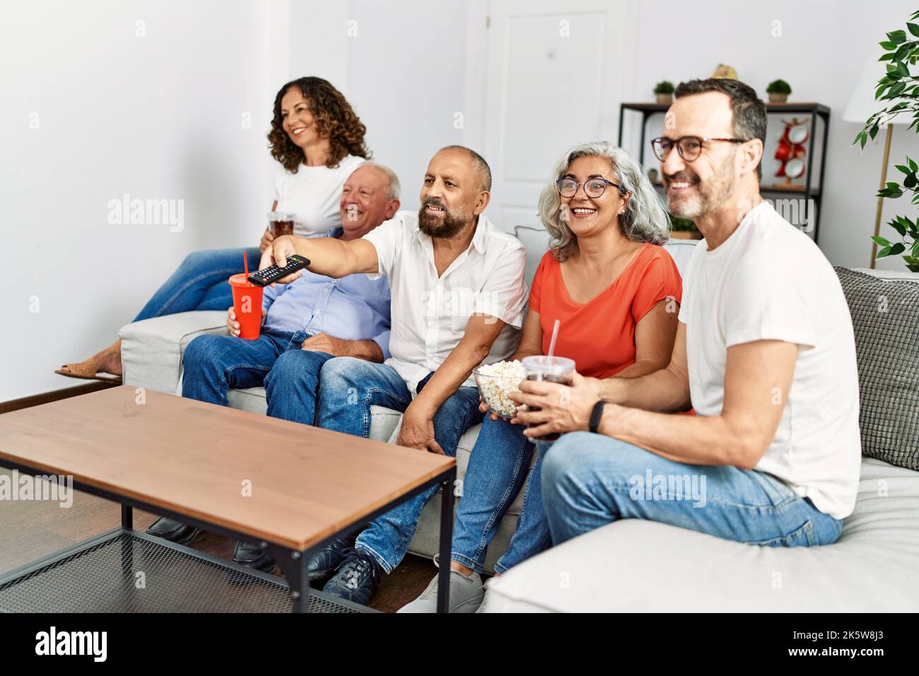 Group of middle age friends smiling happy watching film at home Stock ...