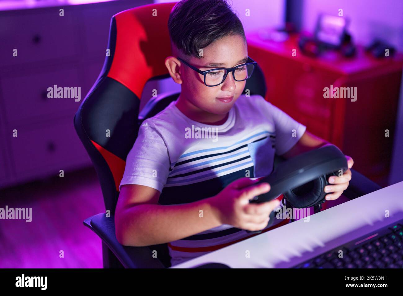 Adorable hispanic boy streamer smiling confident holding headphones at ...