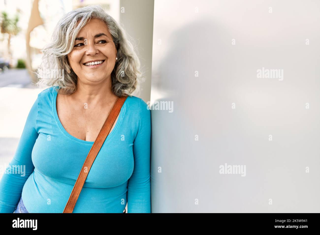 Middle age grey-haired woman smiling happy standing at the city Stock ...