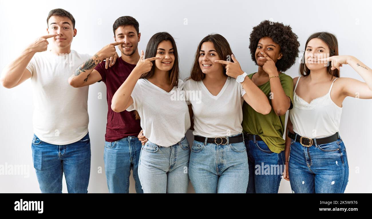 Group of young friends standing together over isolated background ...