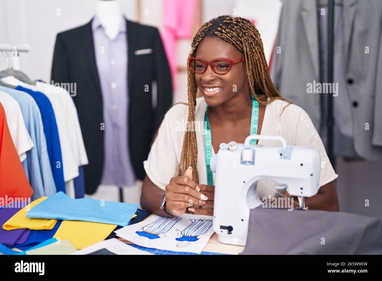 African american woman tailor smiling confident speaking at tailor shop ...