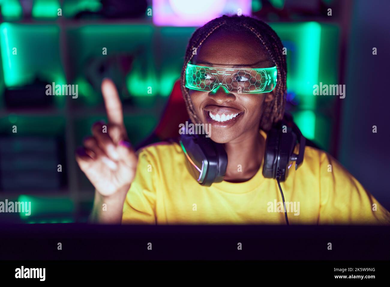 African american woman streamer playing video game using virtual ...