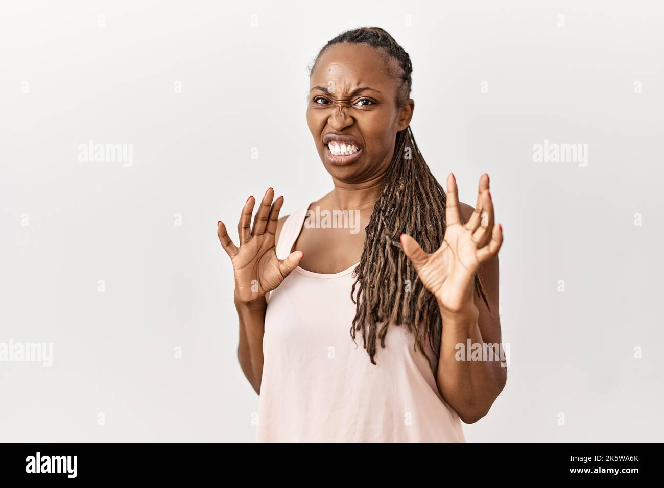 Black woman with braids standing over isolated background disgusted ...