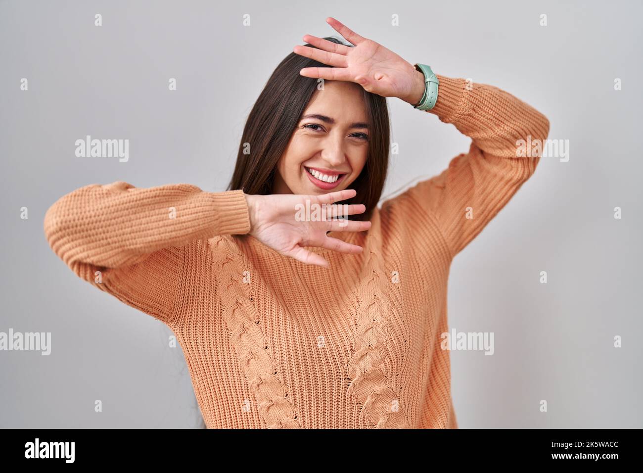 Young brunette woman standing over white background smiling cheerful ...
