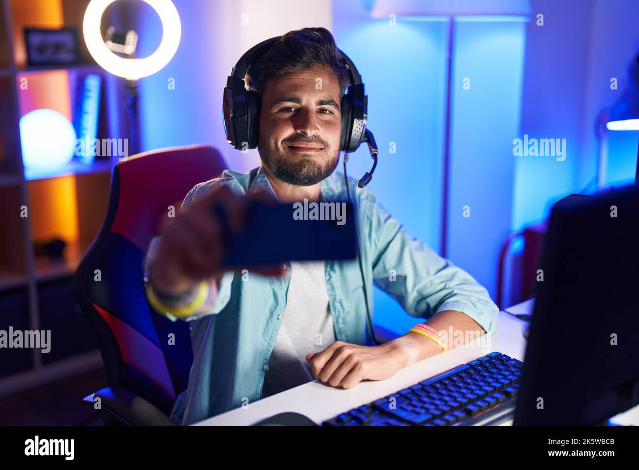 Young hispanic man streamer smiling confident make selfie by smartphone ...