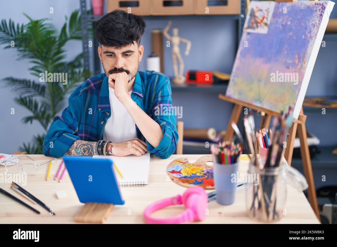 Young hispanic man artist using touchpad drawing at art studio Stock ...