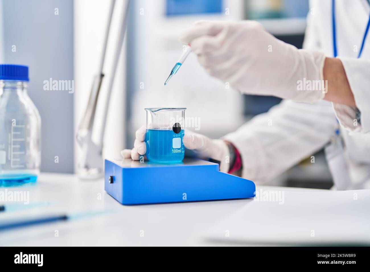 Young hispanic man scientist measuring liquid at laboratory Stock Photo ...