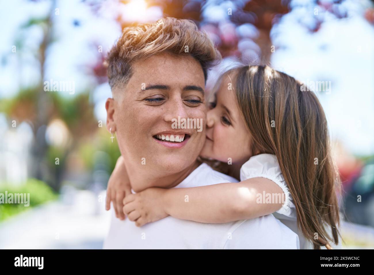 Father and daughter smiling confident hugging each other holding on back at park Stock Photo - Alamy