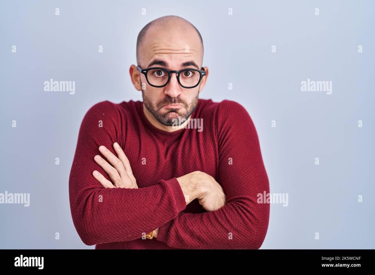 Young bald man with beard standing over white background wearing ...