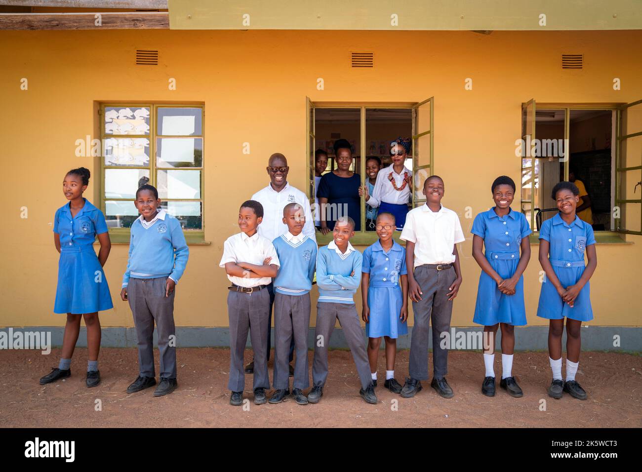 Teachers and pupils wait to meet the Countess of Wessex at Molefe ...