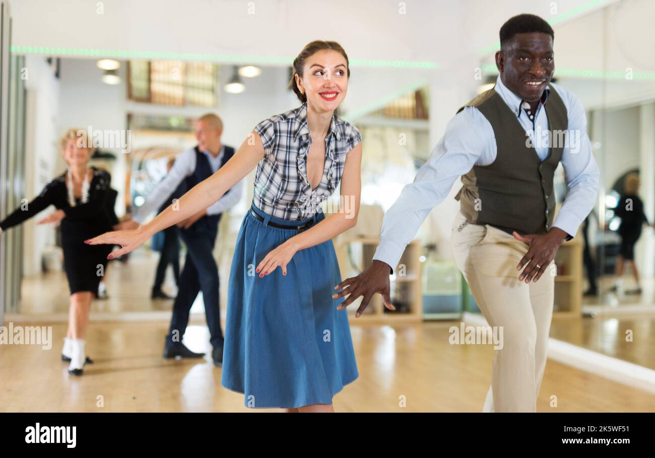 Woman with african man practising charleston dancing Stock Photo - Alamy