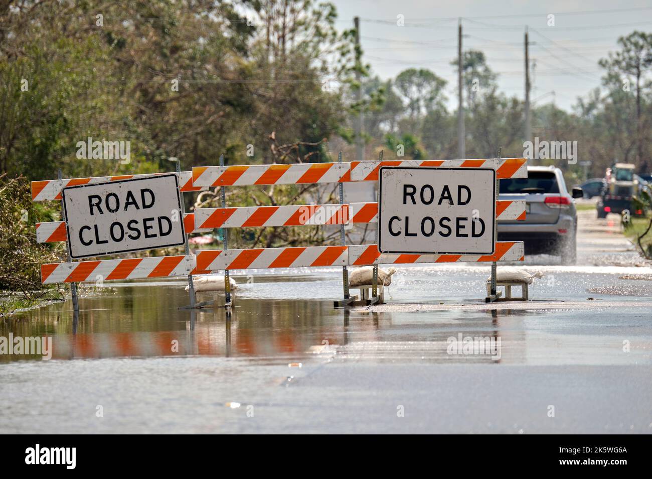 Road closed for roadworks and danger of flooding with warning signs ...