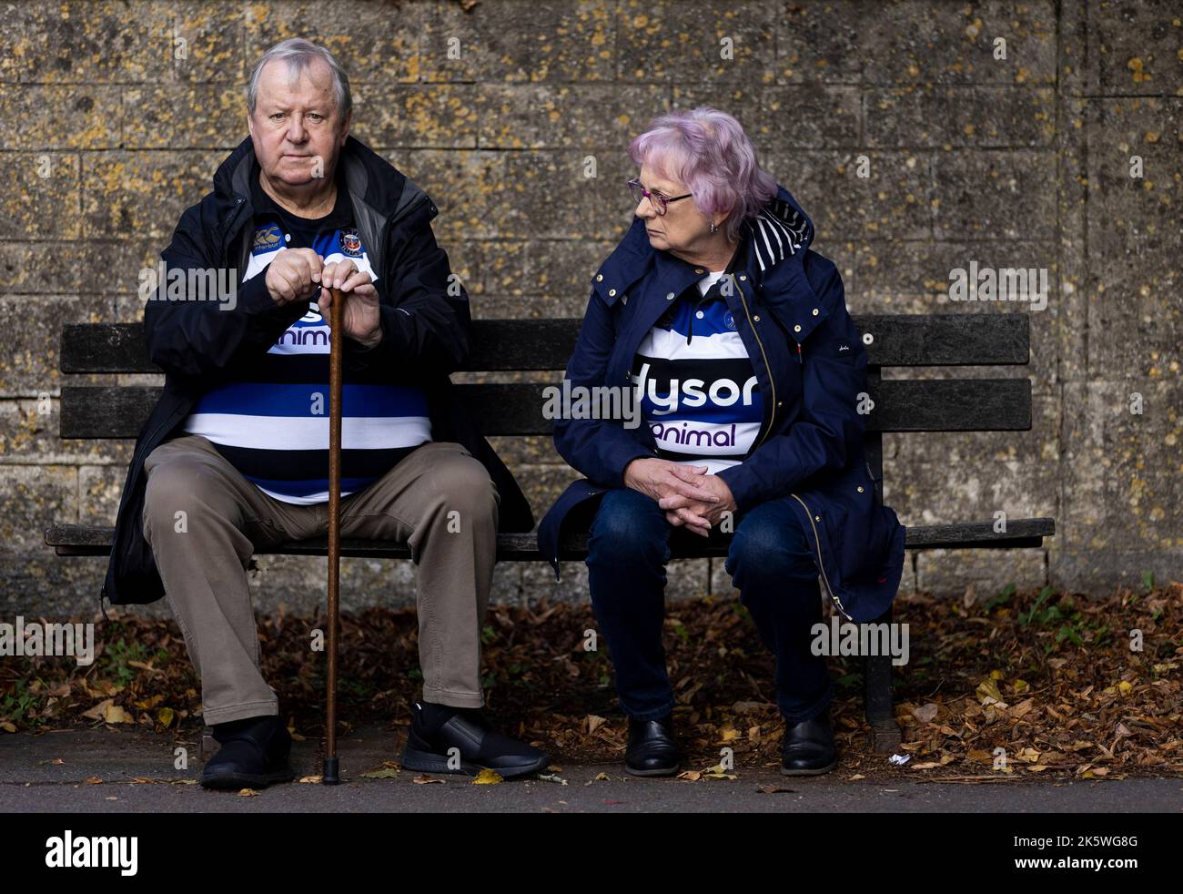 Bath Rugby fans sit on a bench near the ground before the Gallagher ...