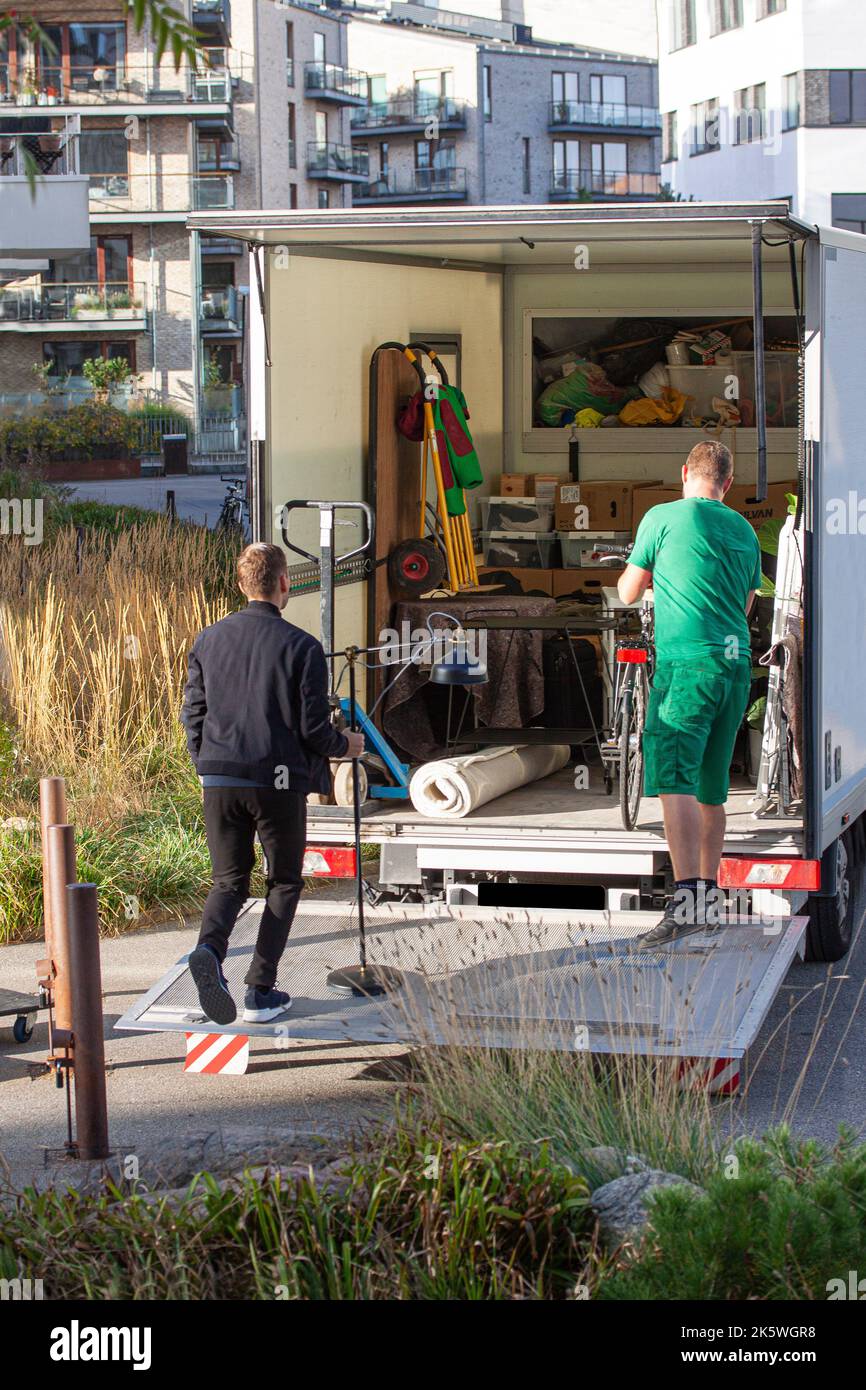 Family moves with their belongings in an unidentified closed transport ...