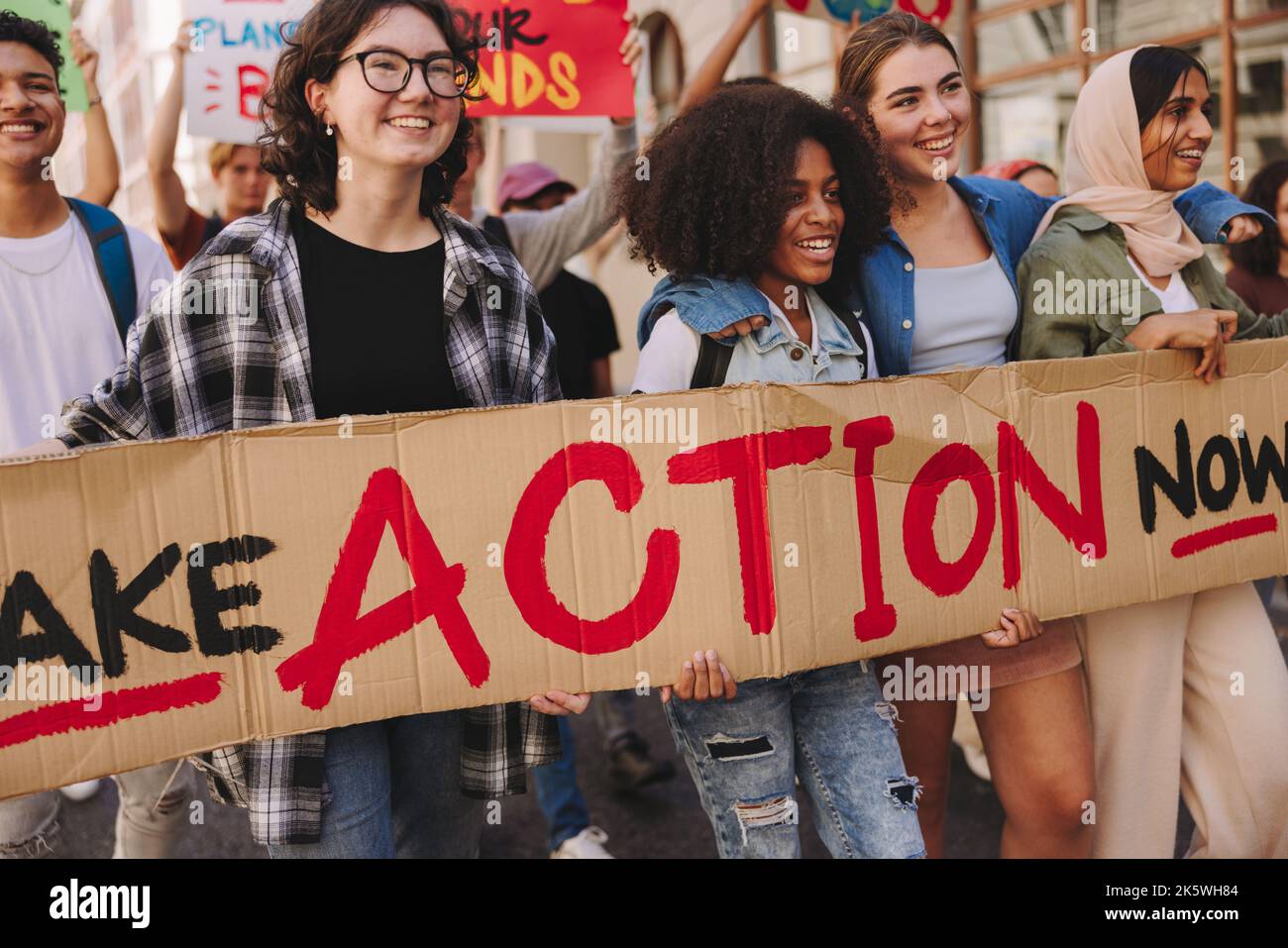 Youth climate demonstration. Vibrant young people holding a banner ...