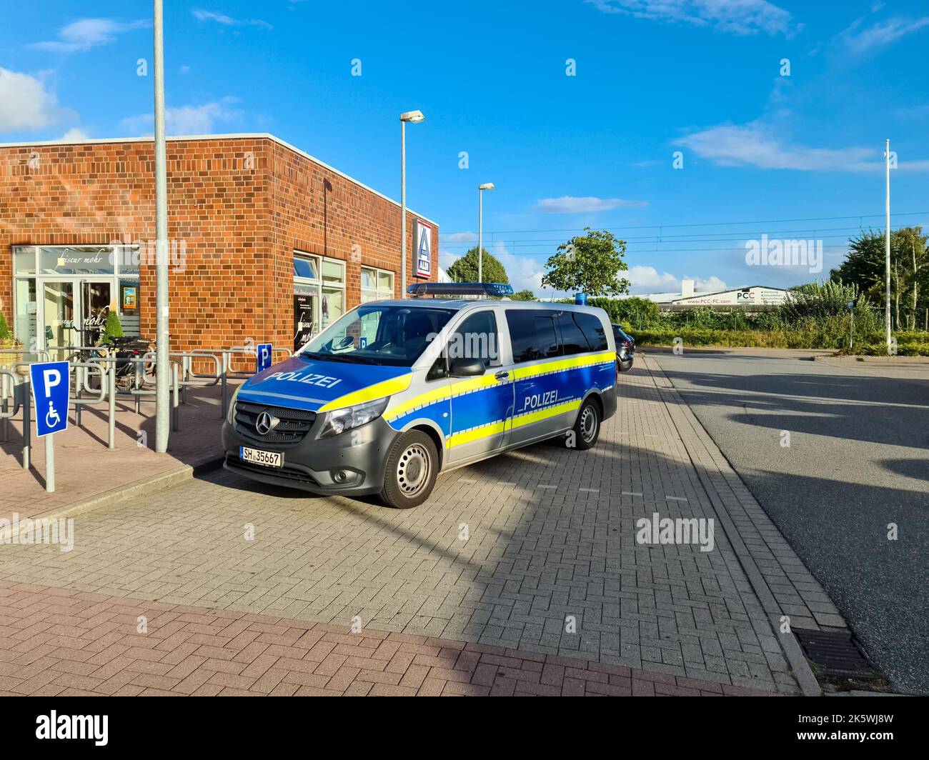 A German police bus parked across the car park in front of a ...