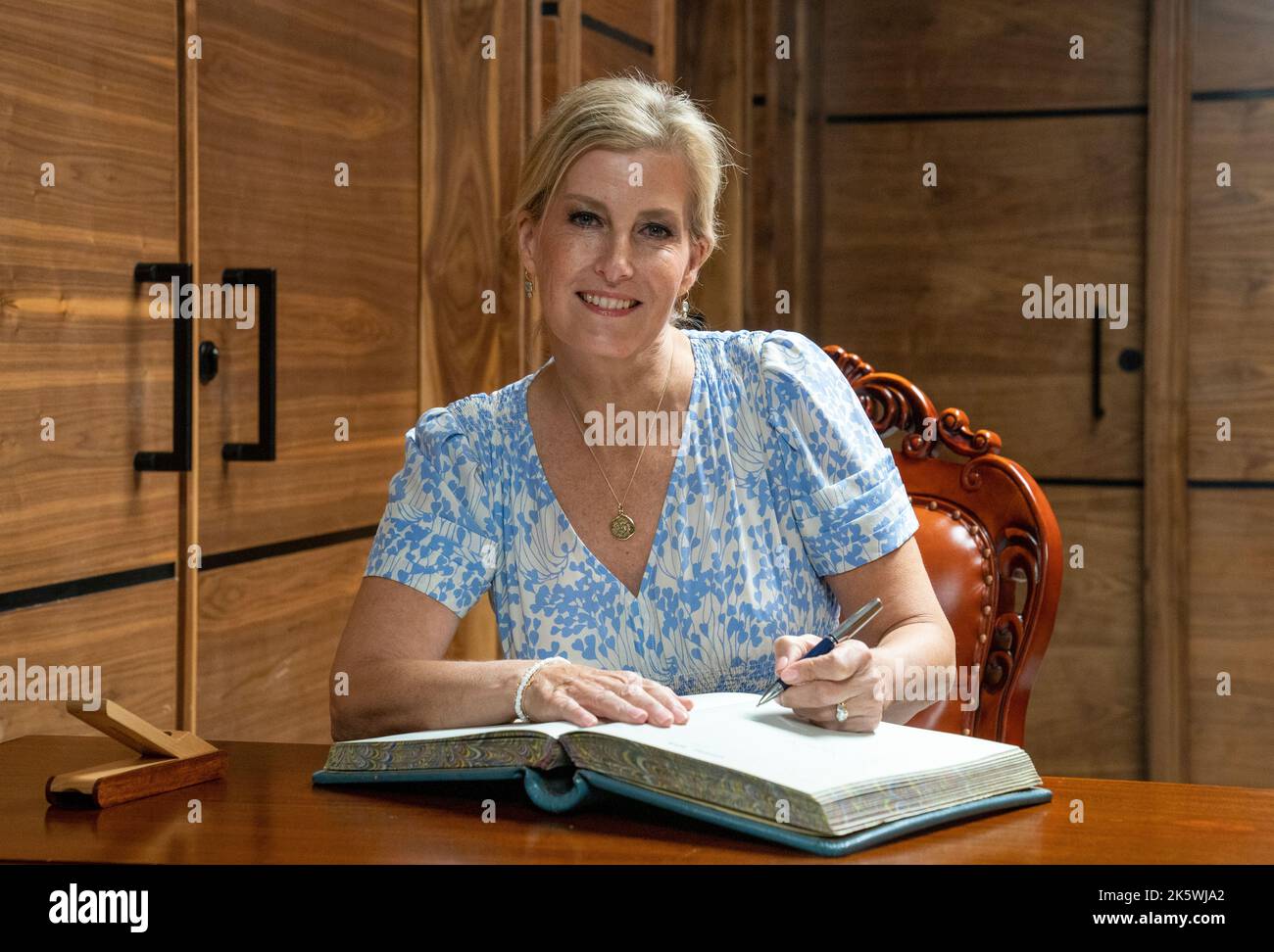 The Countess of Wessex signs the visitor book during a visit to the ...