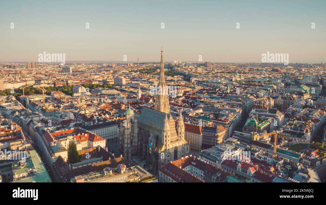 An aerial view of cityscape Vienna surrounded by buildings under blue ...