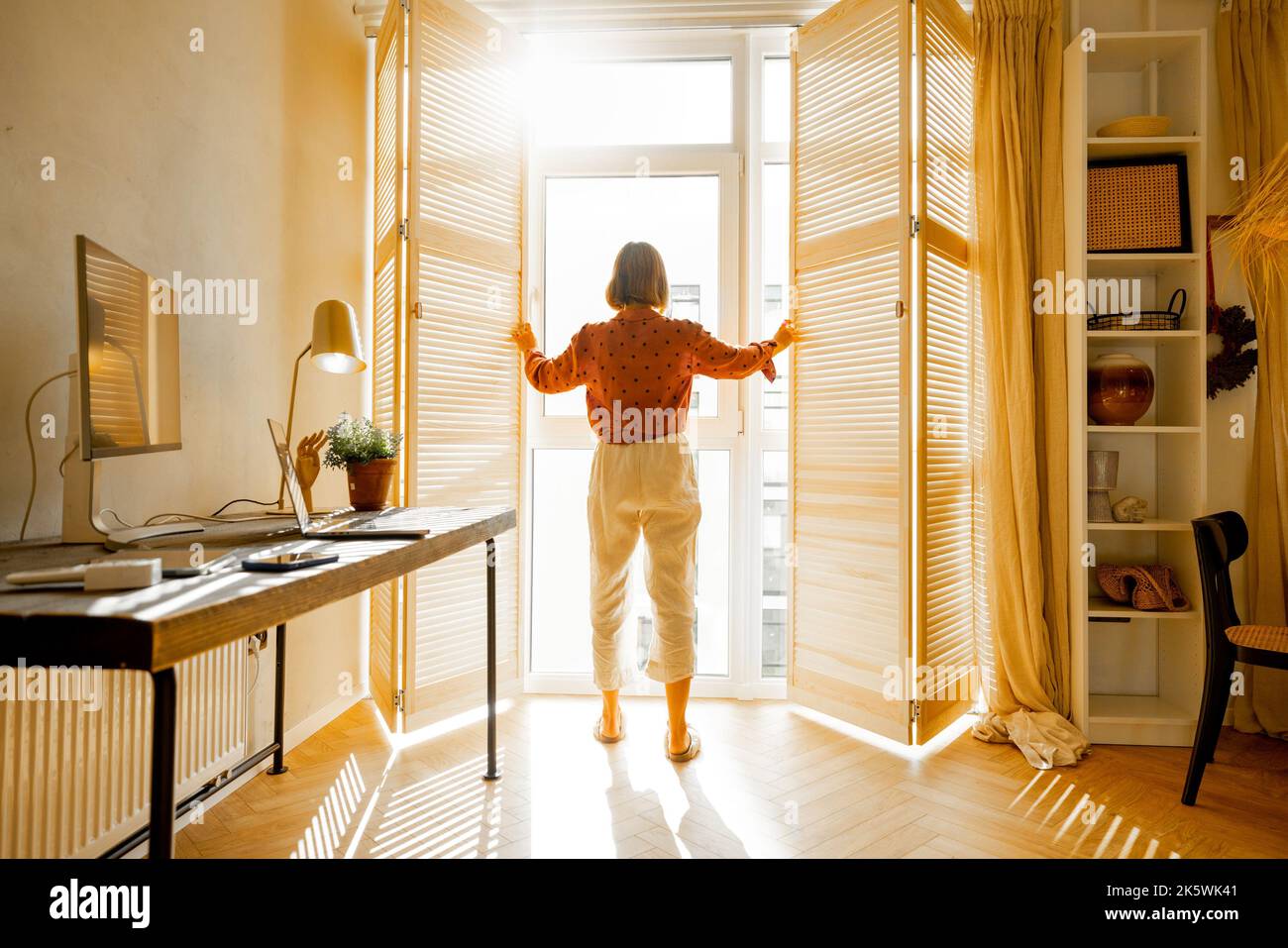 Woman opens curtain hi-res stock photography and images - Alamy
