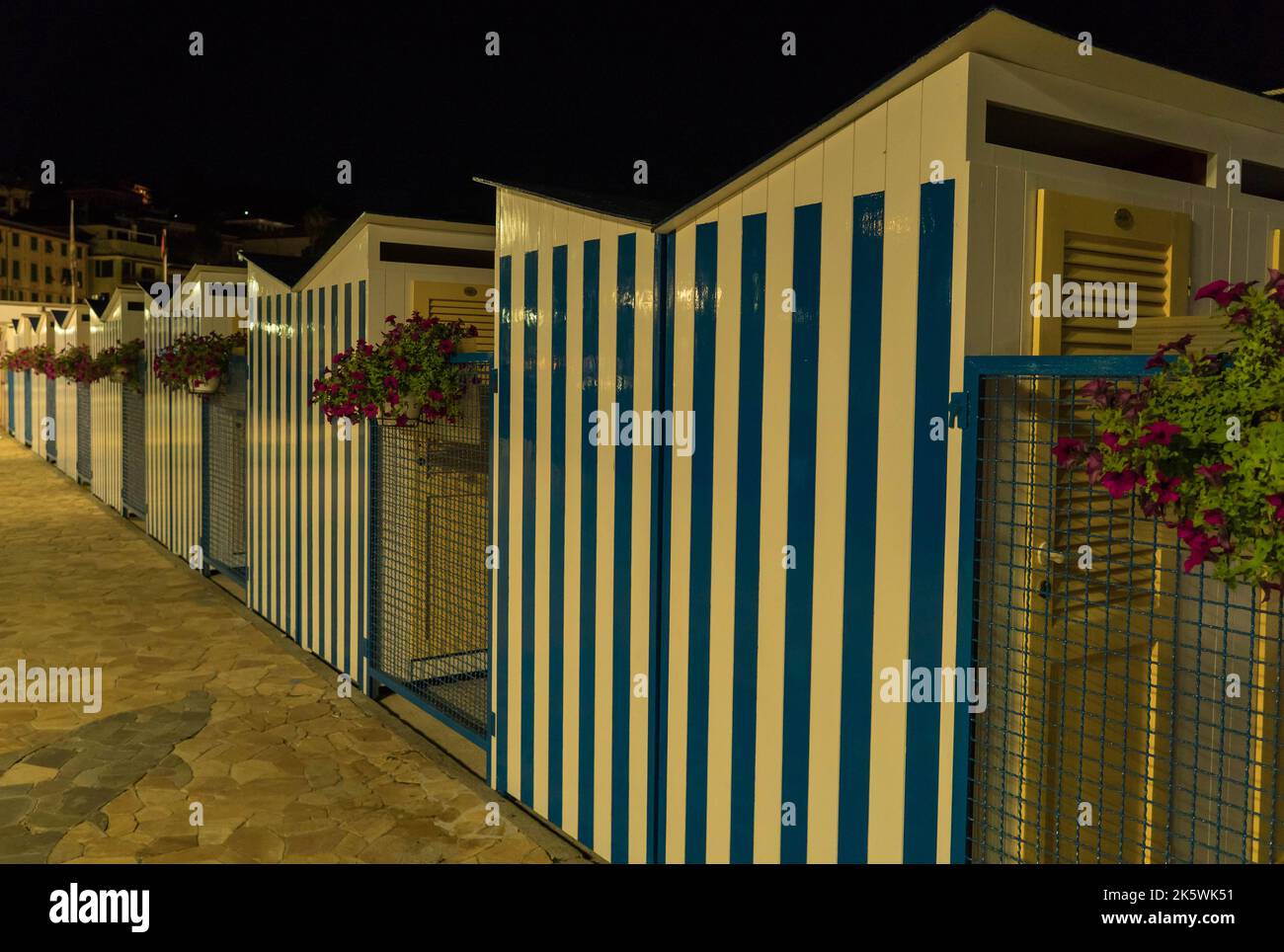 Blue striped beach huts line the promenade at Santa Margherita Liguria ...