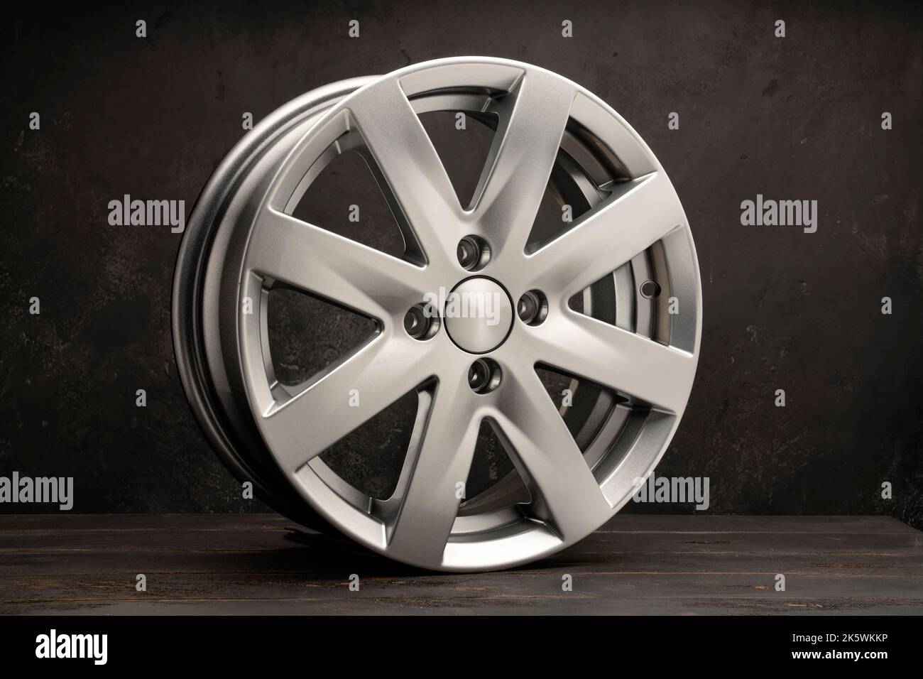 new grey alloy wheels on a dark textured black background. a wheel for ...