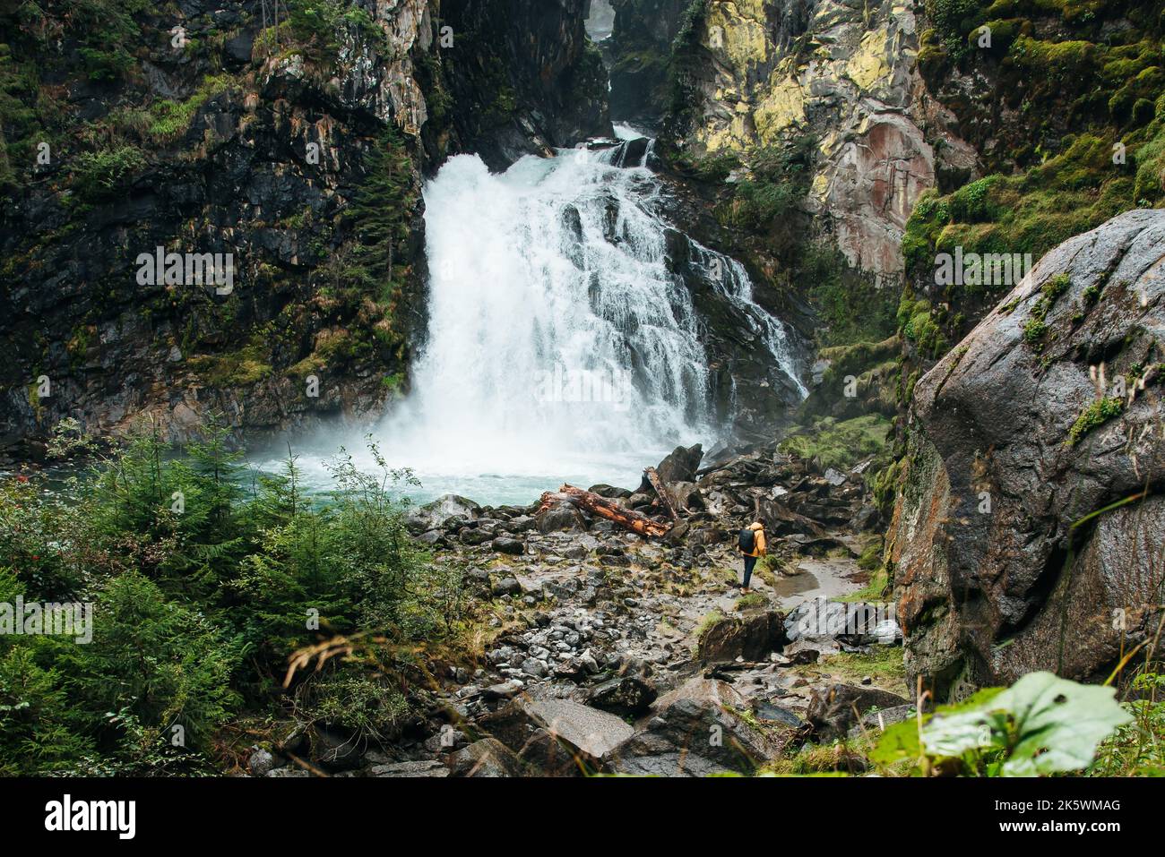 landscape photo of Riva waterfall at Dolomites with a brave hiker ...
